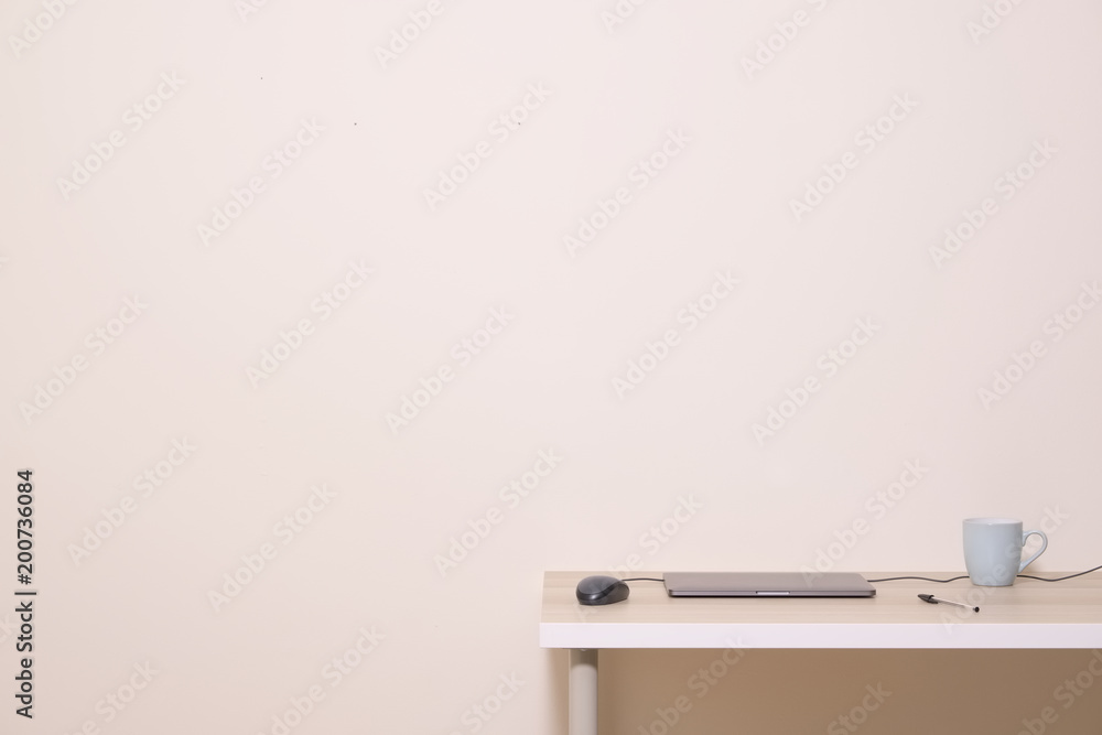 Blank office desk work background empty wall laptop cable mouse pen cup ...