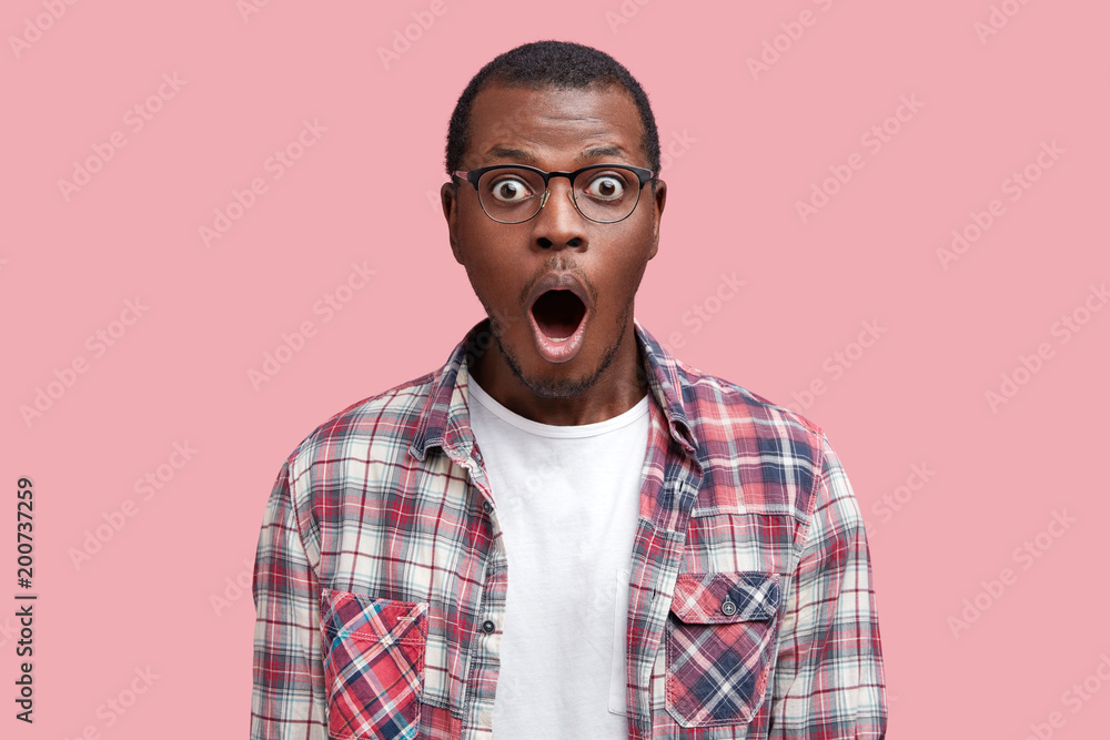 Oh my God. Surprised dark skinned African American male stares at ...