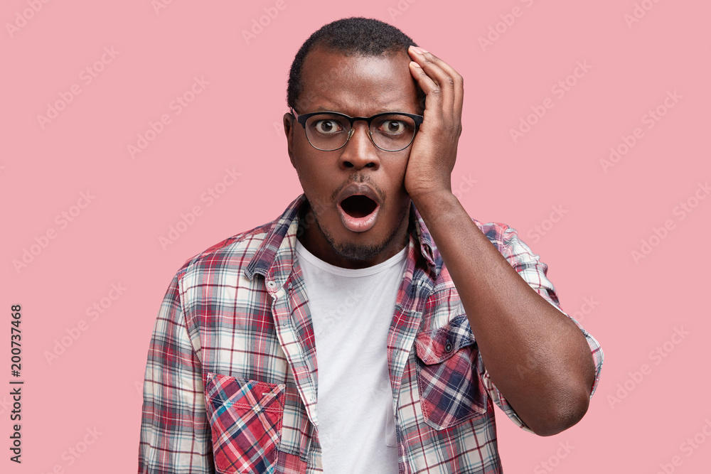 Embarrassed attractive African American male with shocked expression ...