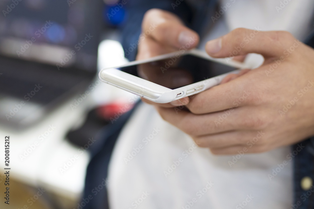 young hands with a mobile phone in the foreground Stock Photo | Adobe Stock