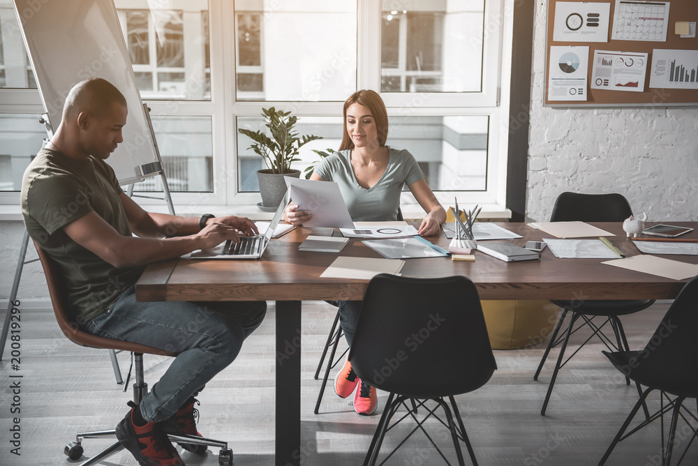 Guy and girl working at the office desk together. Man using computer ...