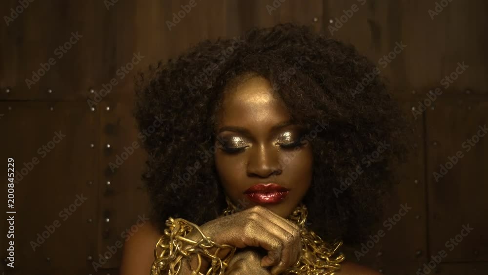 Charming african woman with big red glossy lips, golden eyeshadows and ...