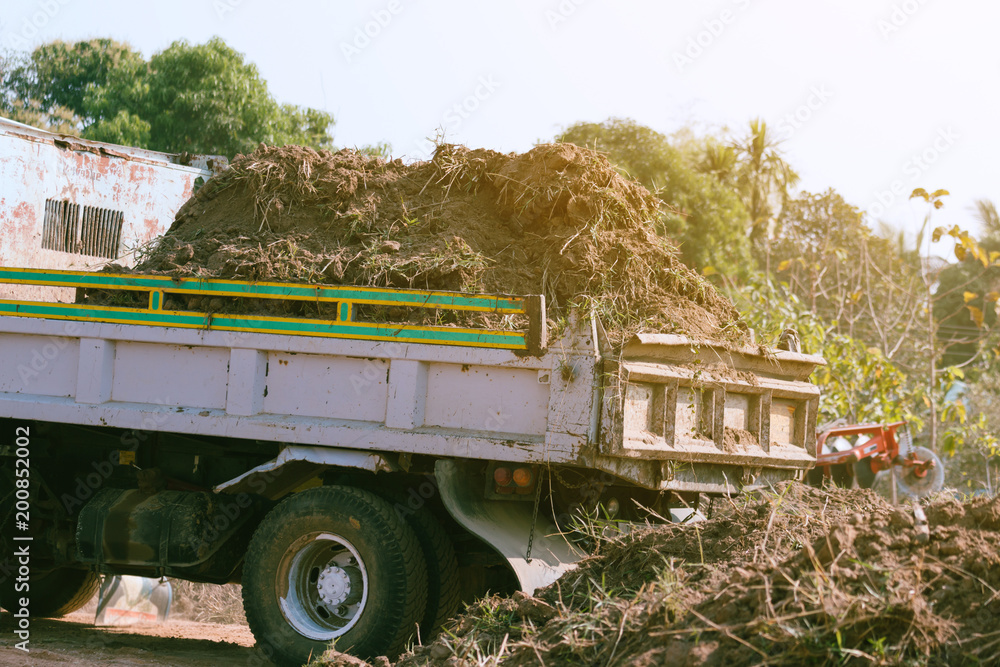 dump truck preparing ground for landscape improvement at property ...