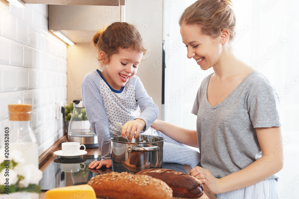 preparation of family breakfast. mother and child daughter cook ...