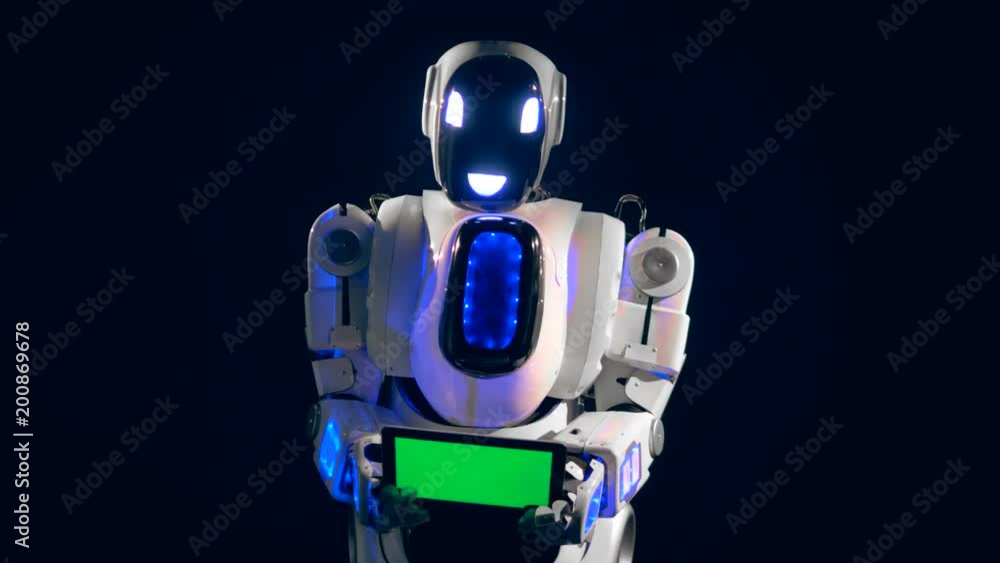 White robot turns to camera, holding a green screen board. Stock Video ...