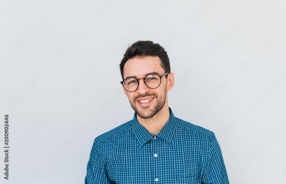 Portrait of handsome smart-looking smiling male posing for social ...