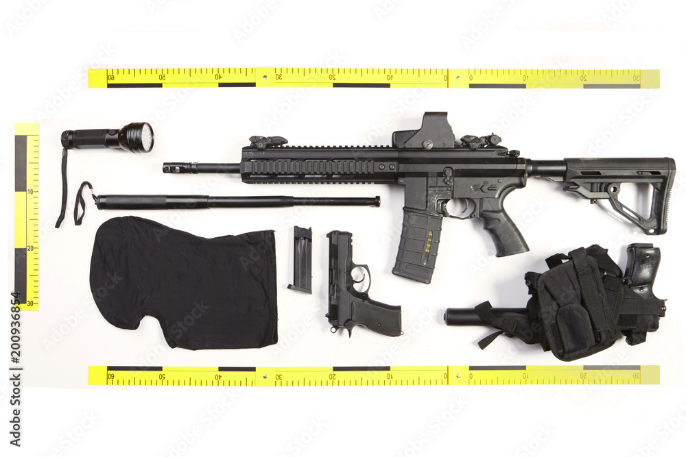Police photo evidence of seized automatic gun and other weapons and ...