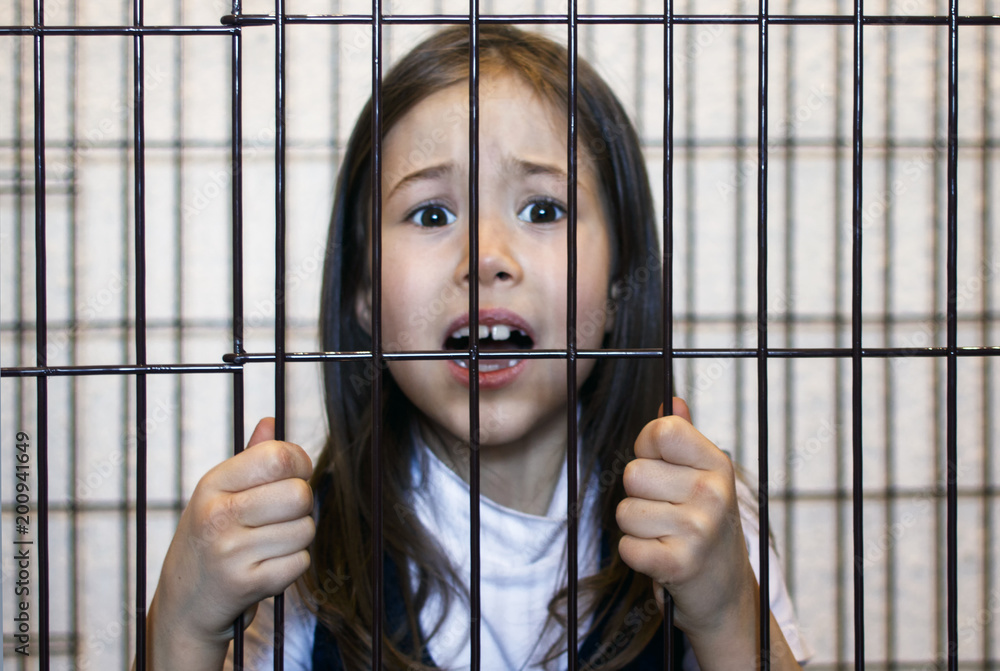 The little girl is locked in an iron cage. Restriction of the rights of ...