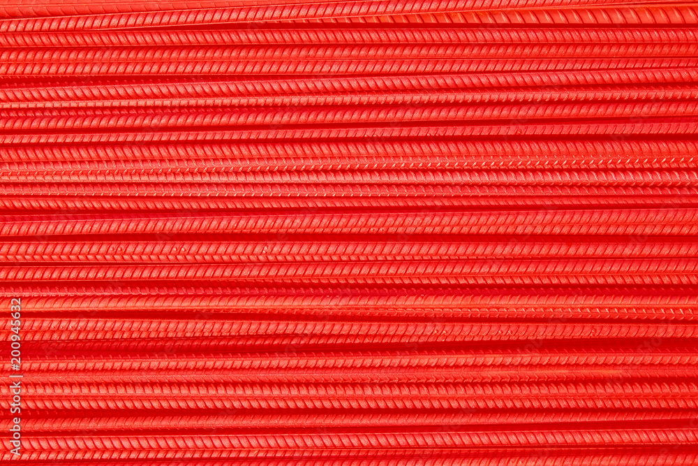 Colorful stack of red metal reinforcement bars with periodic profile ...