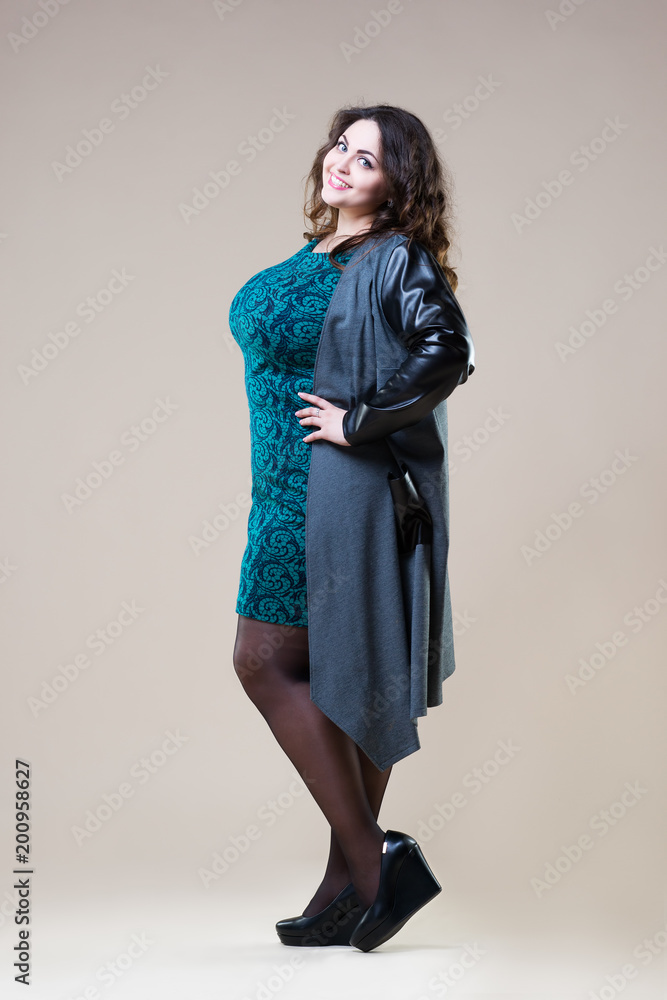 Plus size fashion model in casual clothes, fat woman on beige studio ...