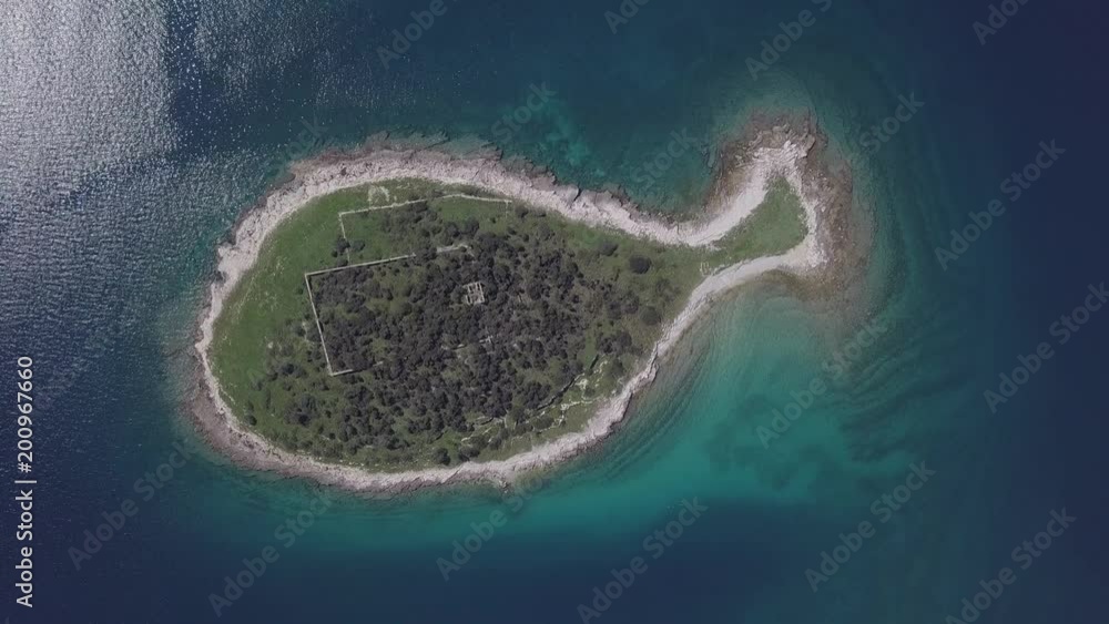 Top aerial view of small desert fish shaped island Gaz in Brijuni ...