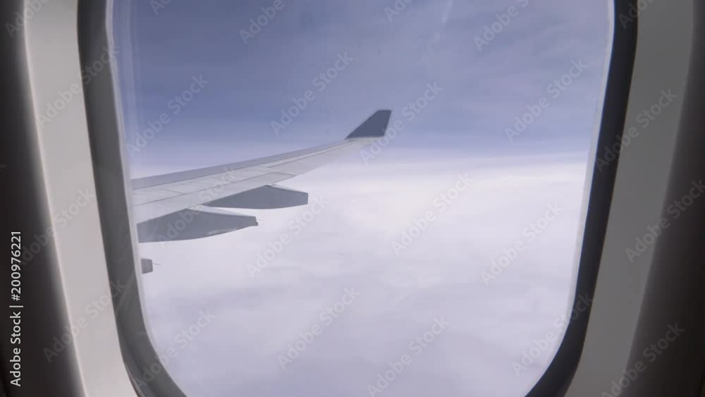POV, CLOSE UP: Unknown person pulls up airplane window shade and ...