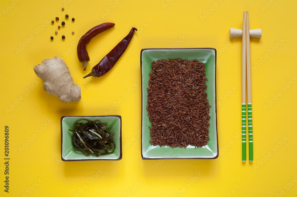 Asian food ingredients, spices and sauces on a bright yellow background ...
