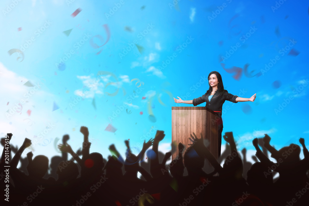 Successful asian business woman giving a speech in front of the people ...