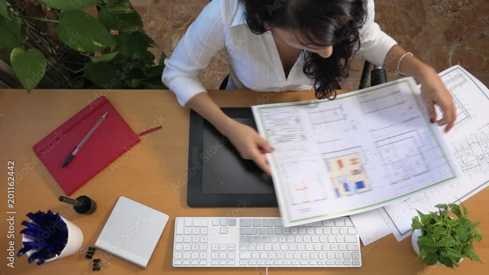Female interior designer planning apartment layout with graphic tablet ...