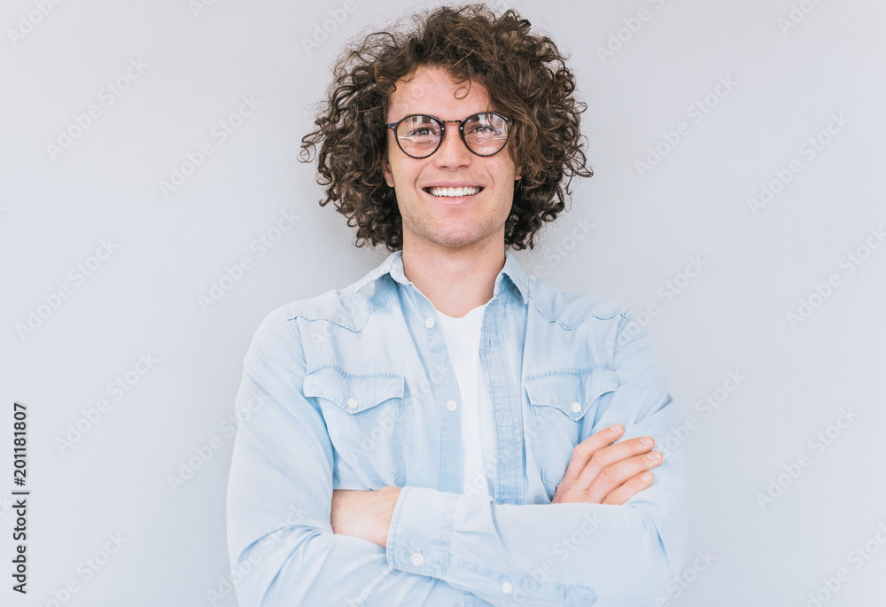 Studio portrait of handsome smart-looking smiling male posing for ...