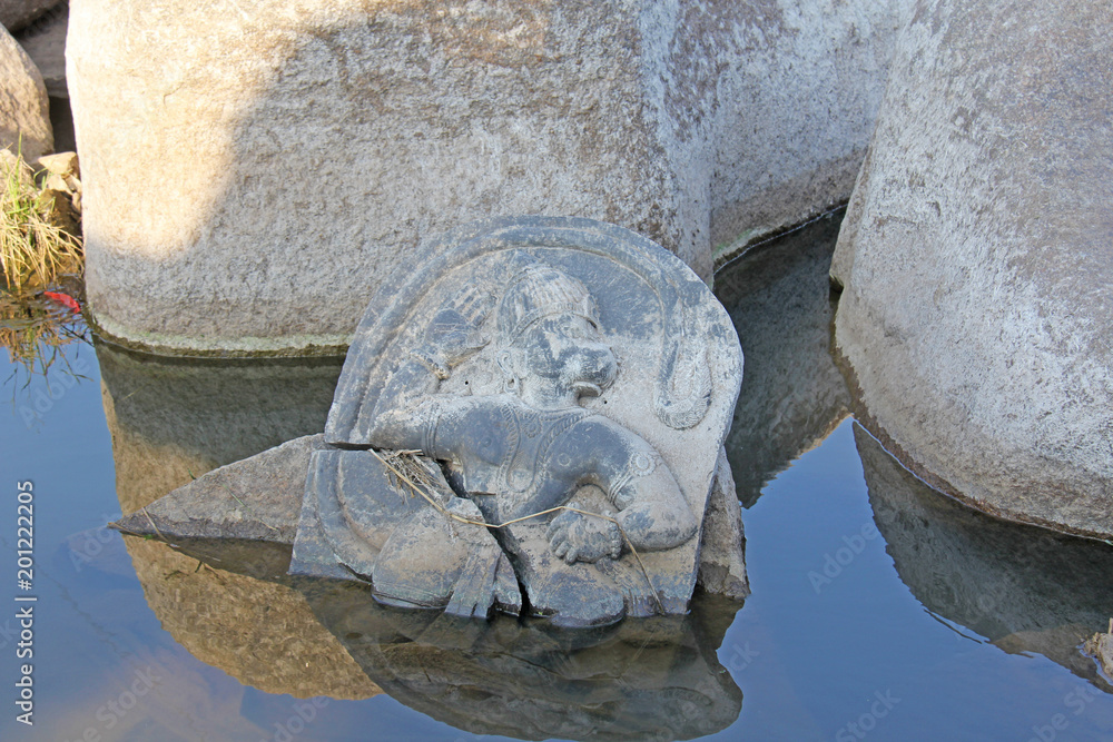 Sacred figure Hanuman is carved from solid stone on the river ...