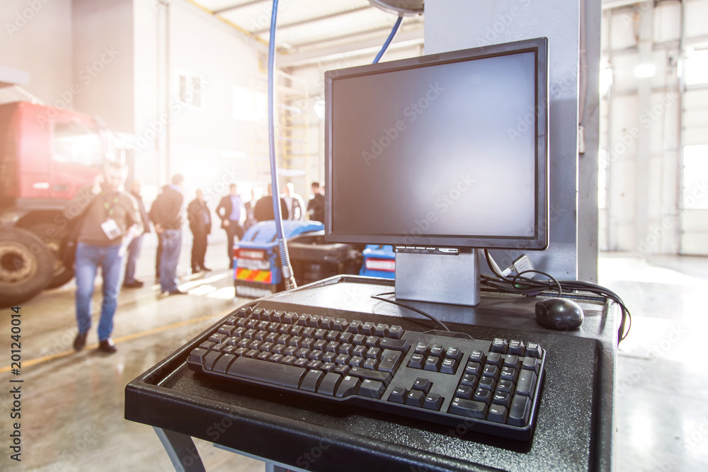 Monitor and keyboard at a stationary service point of trucks in a large ...