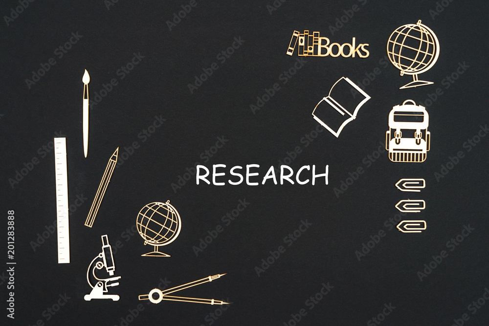 School supplies placed on black background with text research Stock ...