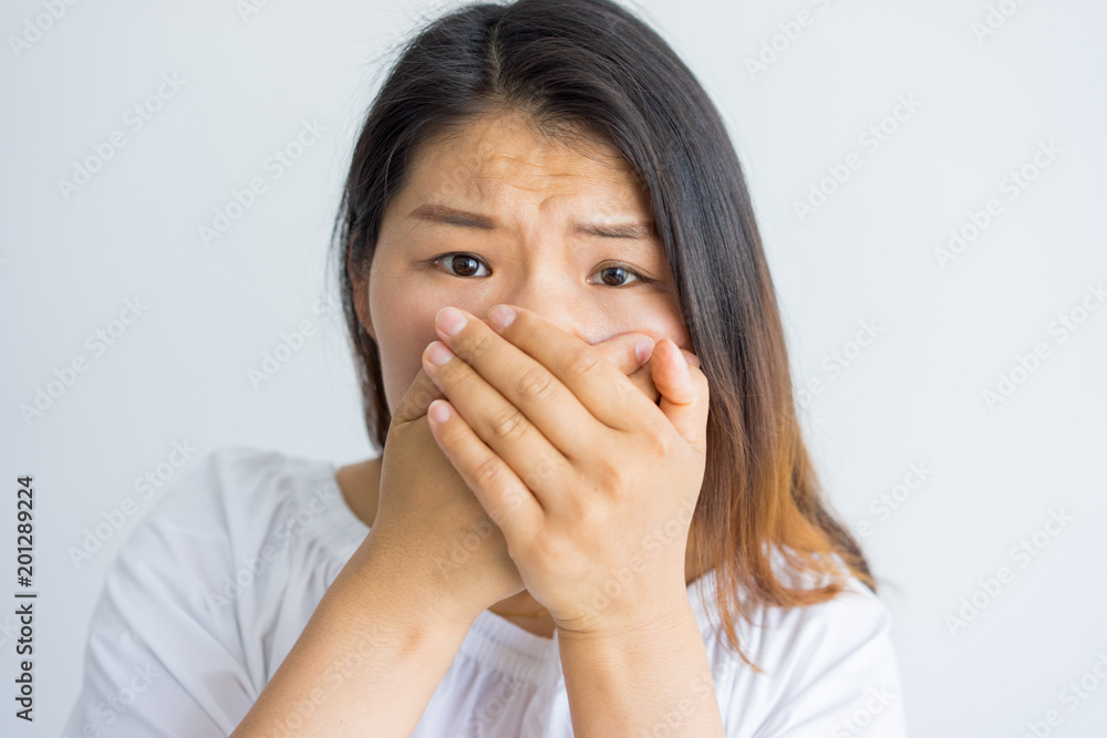 Nervous shocked young Asian woman frustrated with situation looking at ...