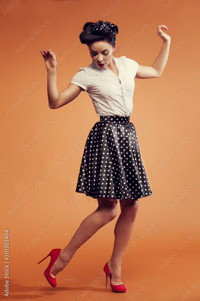 pretty girl on an orange background in the style of pin-up Stock Photo ...