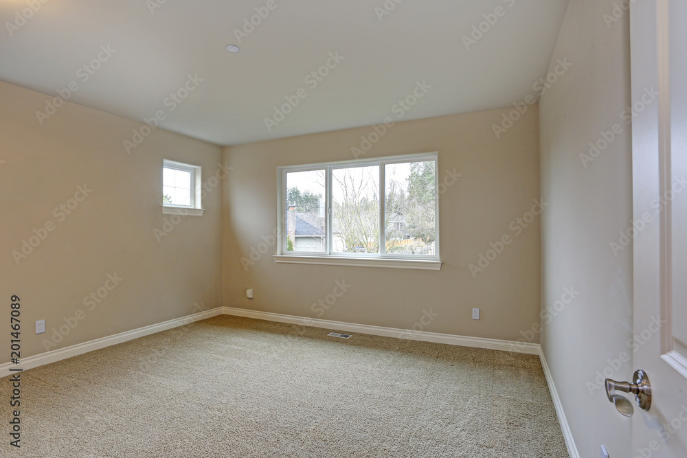 Light beige room interior with a window. Stock Photo | Adobe Stock