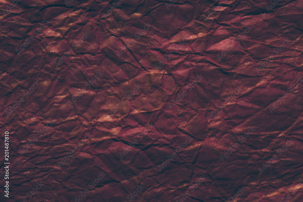 Dark burgundy textured paper background with glowing golden sparkles ...