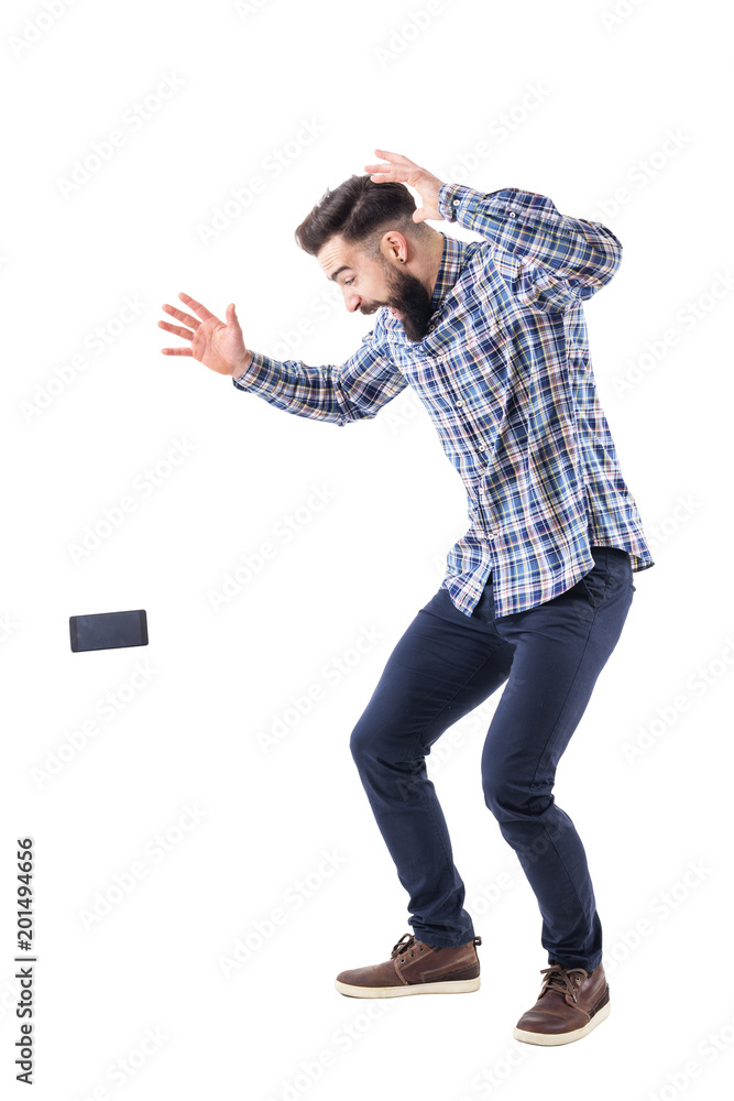 Shocked sloppy clumsy bearded man dropping mobile phone falling on the ...
