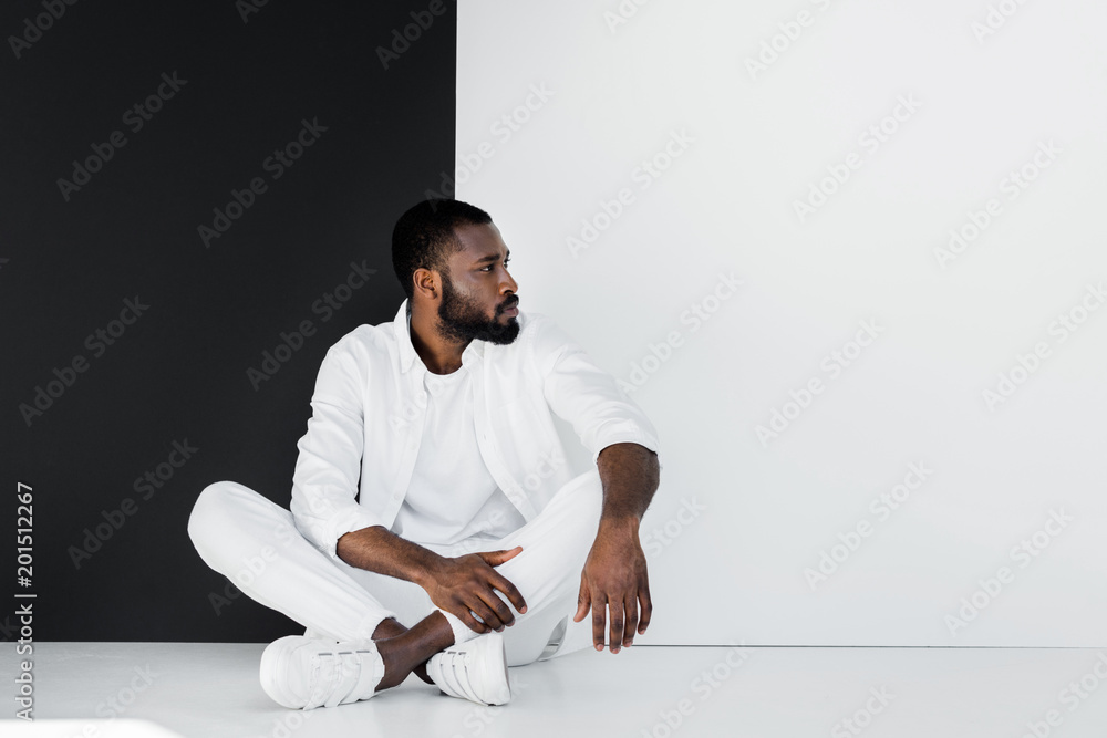 Person Sitting On Ground Facing Away