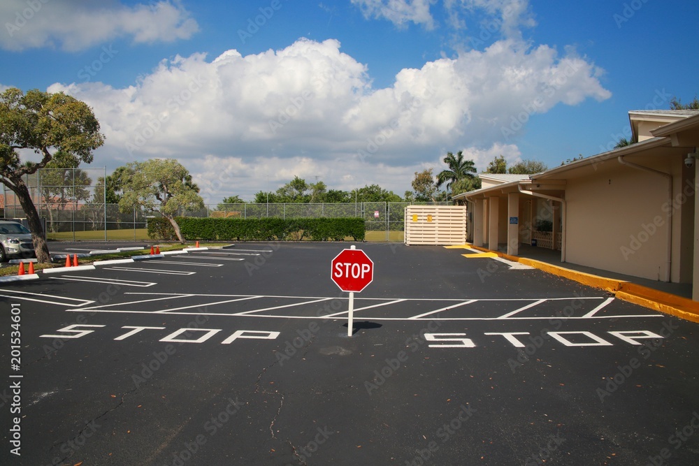 Red and White Stop Sign and Indication Painted on Black Pavement in ...