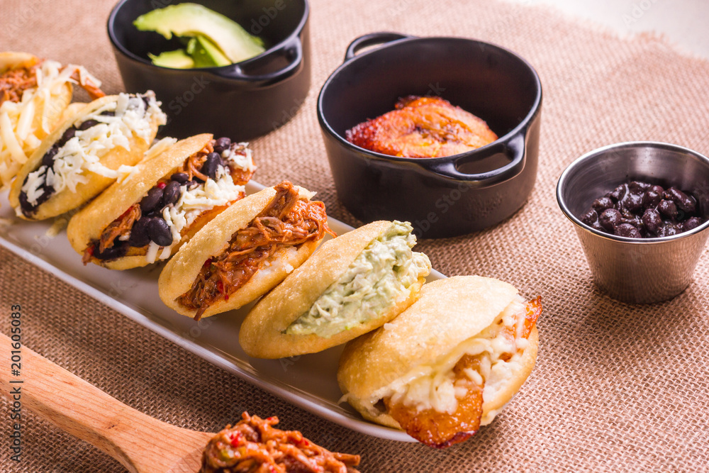 Different types of arepas, meat, black beans, cheese, fried plantain ...