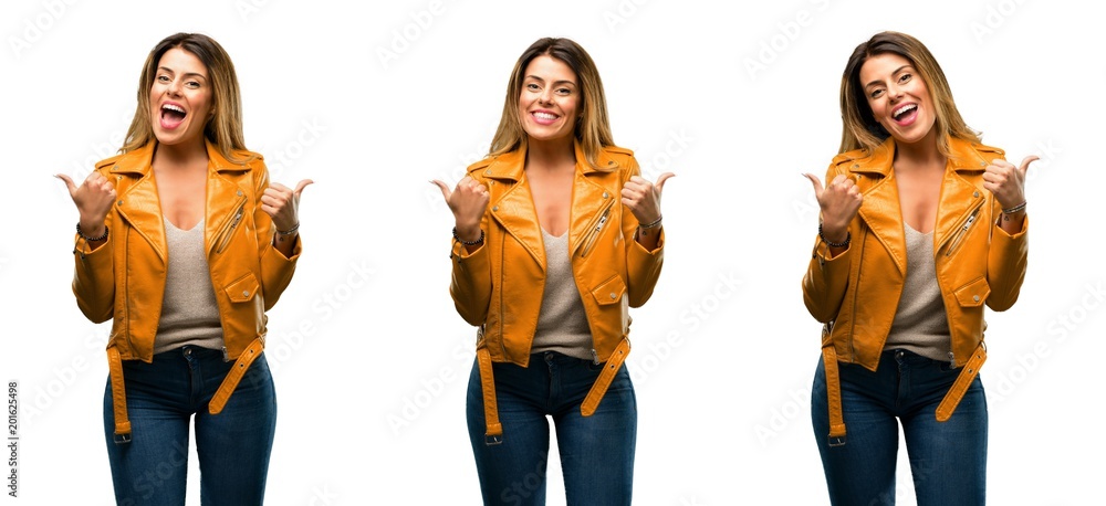 Beautiful young woman smiling broadly showing thumbs up gesture to ...