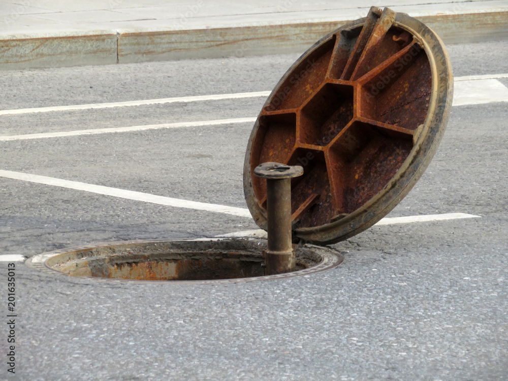 Open manhole on the road. Opened sewer cover, underground repairs Stock ...