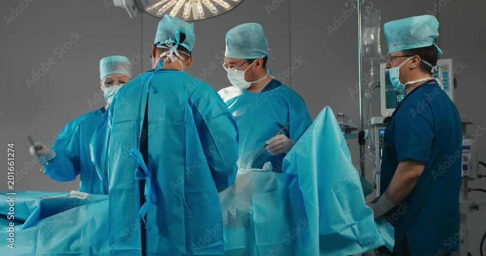 Medical team, doctors performing surgical operation in real modern ...
