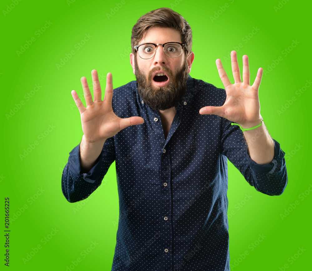 Young hipster man with big beard disgusted and angry, keeping hands in ...