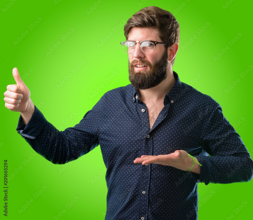Young hipster man with big beard thumb up holding something in his ...