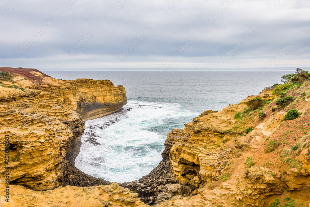 Cloudy sunny summer coast view to a beautiful sandy beach bay and rocky ...