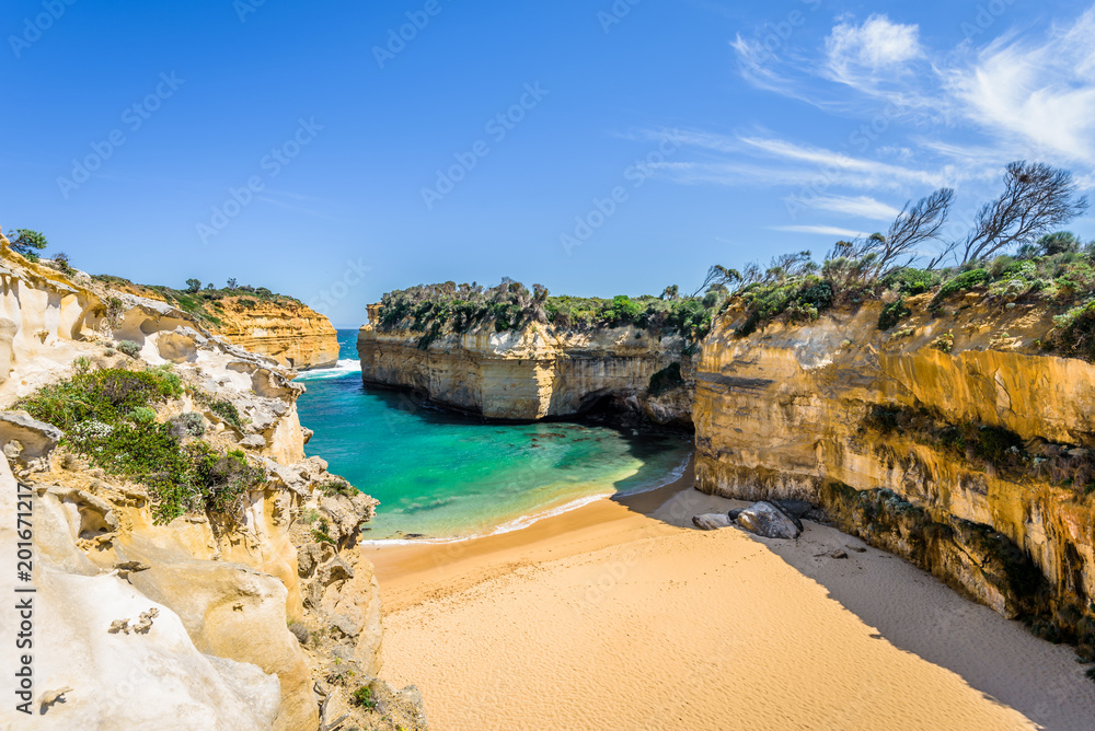 Bright sunny summer coast view to a beautiful sandy beach bay and rocky ...