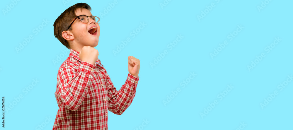 Handsome toddler child with green eyes happy and excited expressing ...