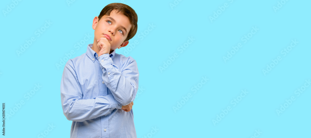 Handsome toddler child with green eyes thinking and looking up ...
