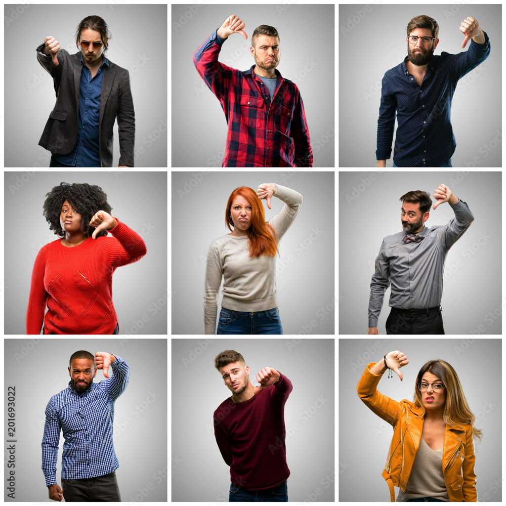 Group of mixed people, women and men showing thumbs down unhappy sign ...