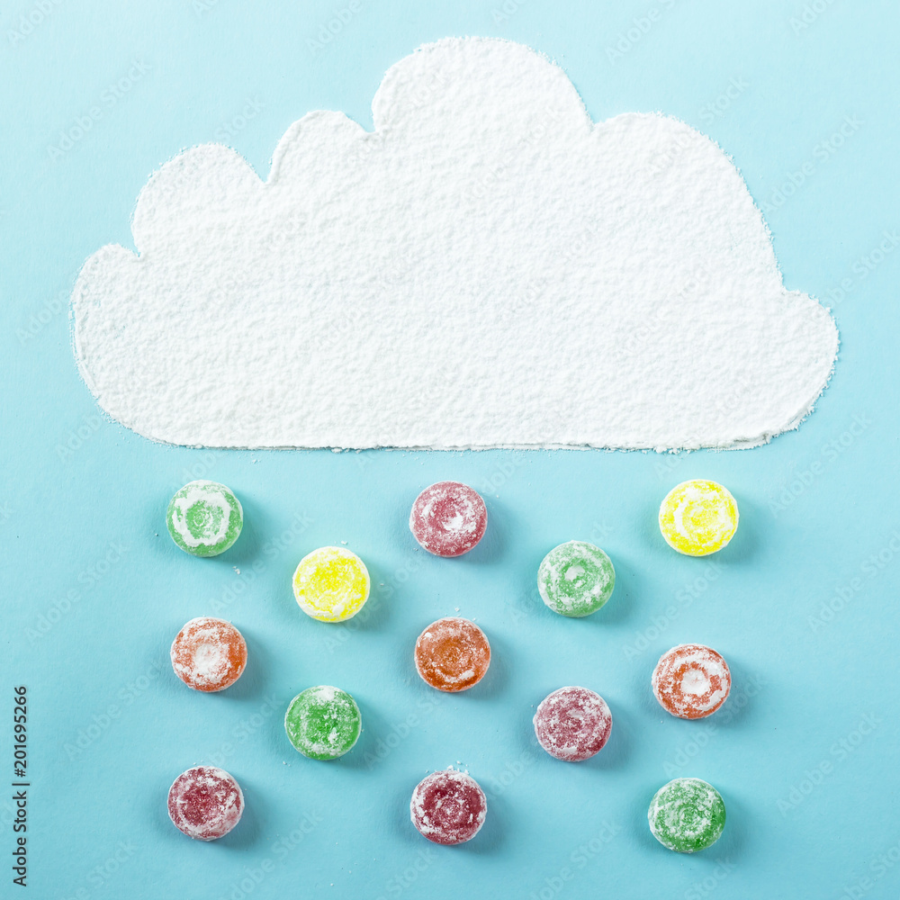 A cloud of powdered sugar from which comes the candy rain lined on a ...