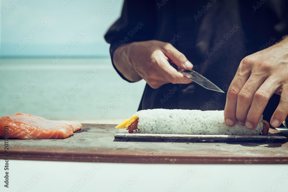 Chef making sushi on sea background Stock Photo | Adobe Stock