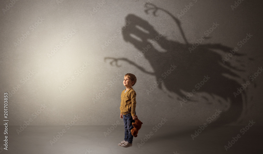 Scary ghost shadow in a dark empty room with a cute blond child Stock ...