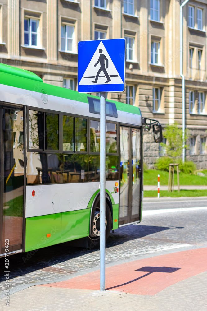 Passenger bus drives past the sign crosswalk on Central cobblestone ...
