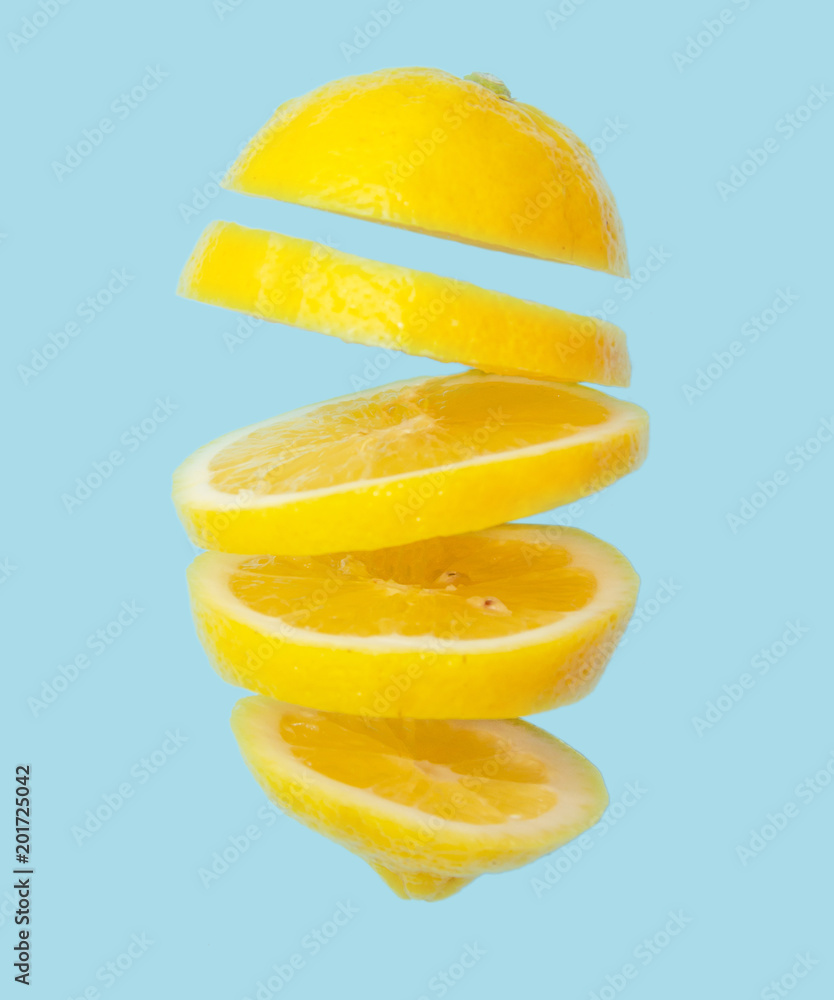 Flying lemon. Sliced lemon isolated on gradient blue background. Levity ...