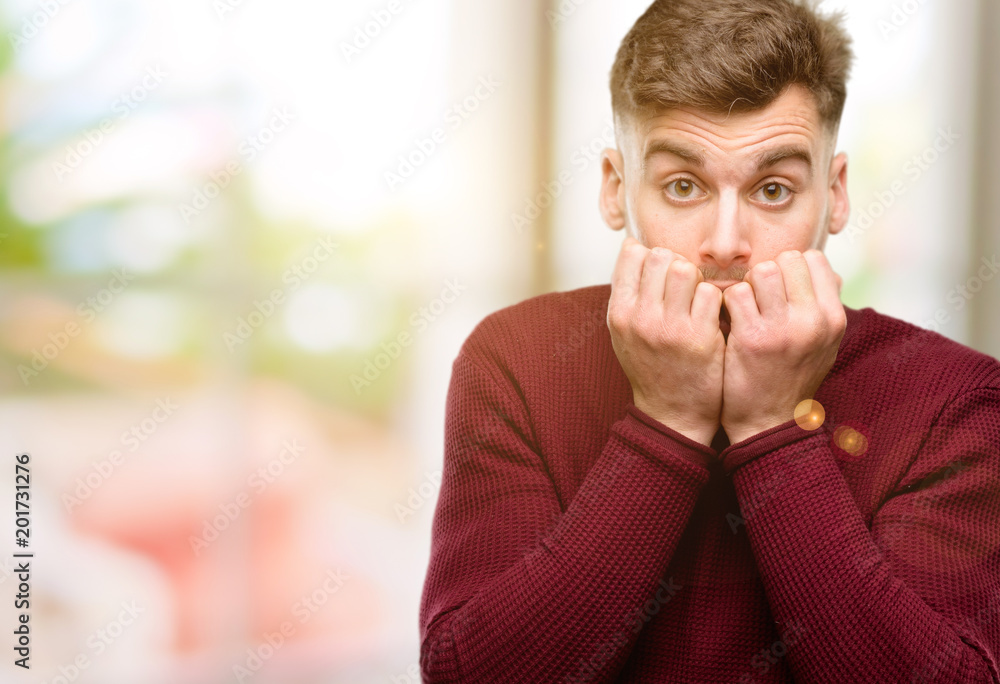 Handsome young man terrified and nervous expressing anxiety and panic ...