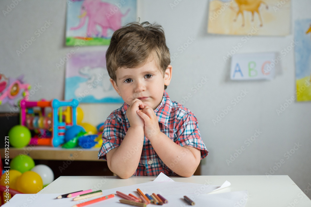 Cute young boy at math classes solving problems and finding solutions ...