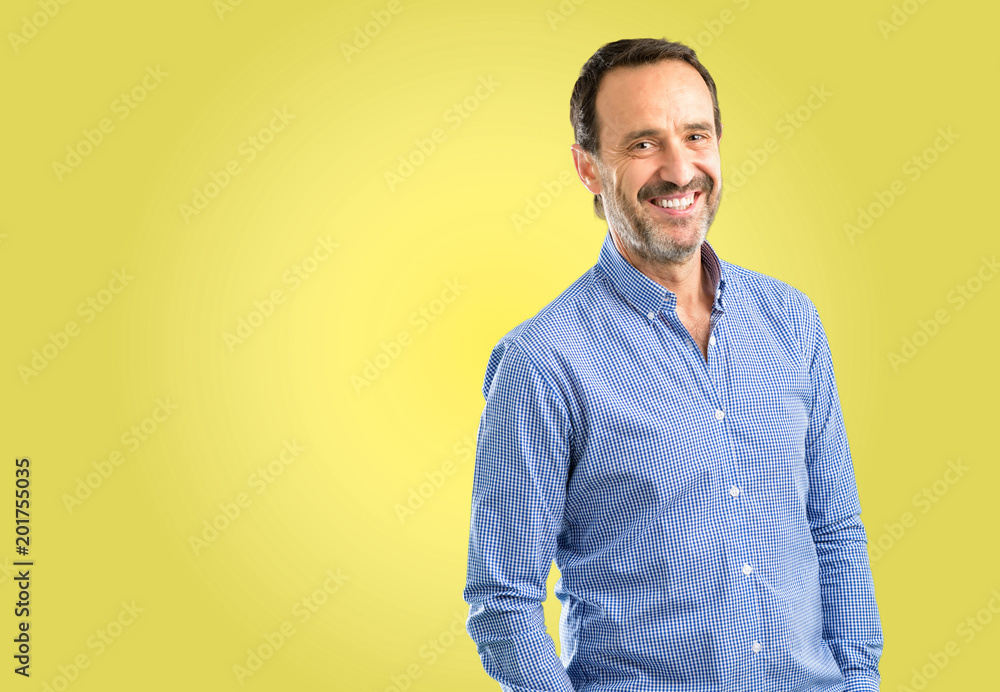 Handsome middle age man confident and happy with a big natural smile ...