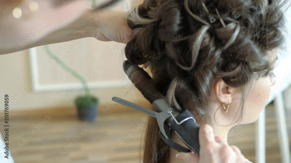 Makeup artist stylist works with model. hairdresser does the hair ...